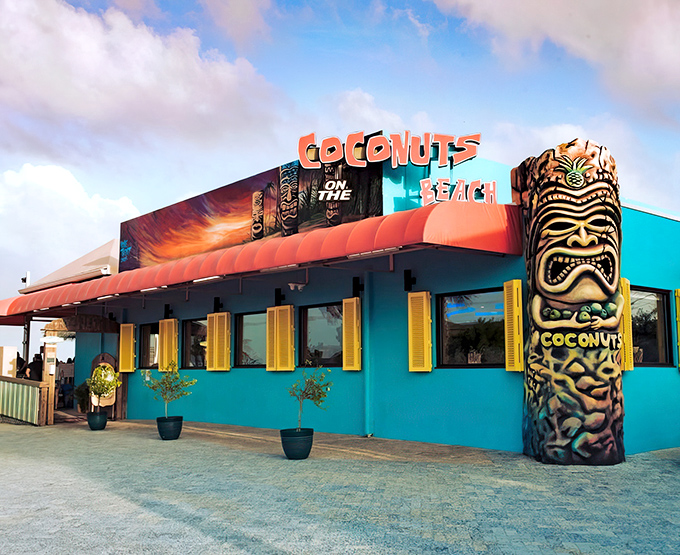 The turquoise beacon of beachside bliss! Coconuts on the Beach announces itself with tiki flair and a color scheme that screams "vacation mode activated."
