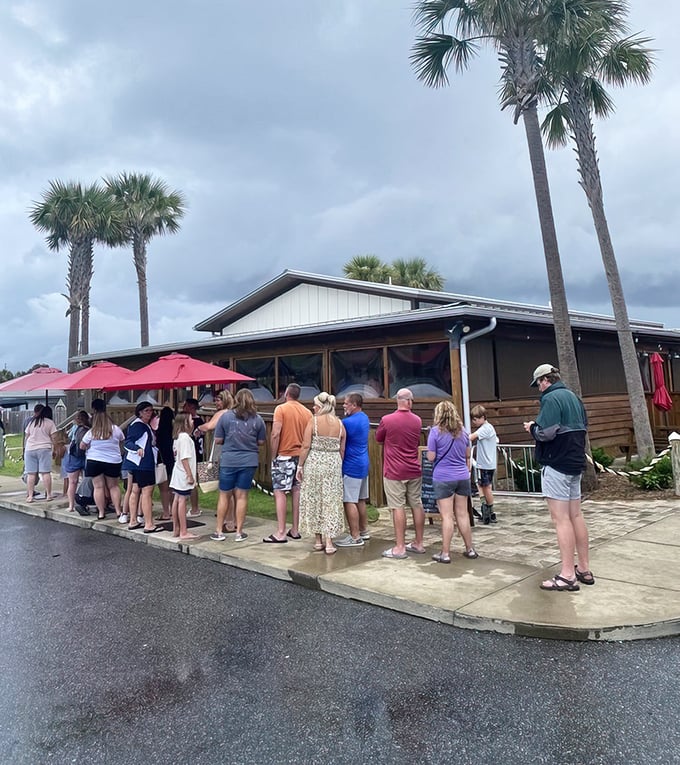 Stewby's Seafood Shanty stands like a beacon of Old Florida charm, palm trees standing guard over this unassuming treasure that promises seafood nirvana.