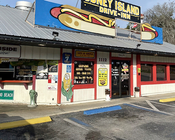 A blue and yellow sign proudly announces your arrival at hot dog paradise, where the motto might as well be "come hungry, leave happy."