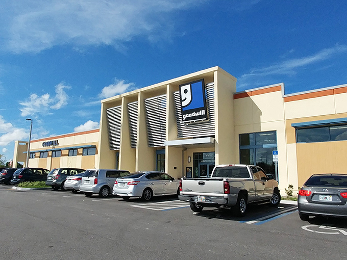 The modern exterior of Goodwill Goldenrod stands like a beacon of bargain hope under Florida's endless blue sky.