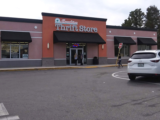 The coral-pink facade of Sunshine Thrift Store beckons like a siren call to bargain hunters across St. Petersburg. Resistance is futile!