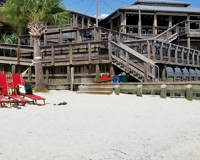 Those red beach chairs offer more than just a place to sit&mdash;they&rsquo;re your sandy-front lounge while the smell of fresh seafood calls from above.