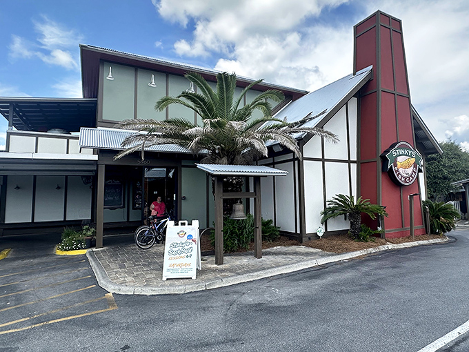 The unassuming exterior of Stinky's Fish Camp belies the culinary treasures within. That distinctive red chimney stands like a lighthouse for hungry seafood lovers.
