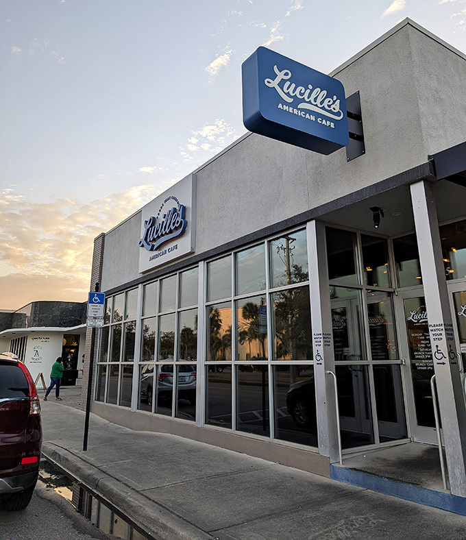 The blue sign of Lucille's glows like a beacon against the sunset sky, promising comfort food salvation for hungry Winter Haven souls.