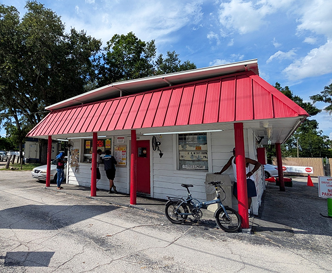 The red-and-white awning isn't just decoration—it's a beacon for fried chicken pilgrims. This humble shack houses flavor that puts fancy restaurants to shame.