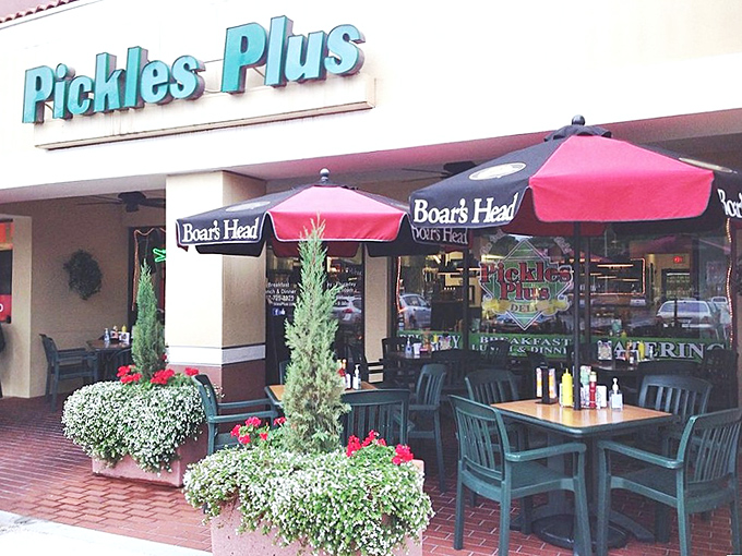 Red umbrellas beckon like culinary lighthouses, guiding hungry souls to this strip mall sanctuary where deli dreams come true.