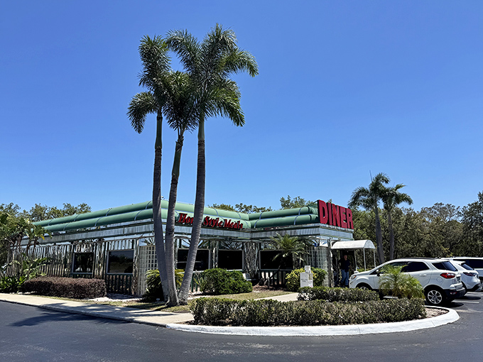 The classic stainless steel exterior of Sebring Diner gleams under the Florida sun like a time machine disguised as a restaurant. Those palm trees aren't just decoration&mdash;they're sentinels guarding a temple of comfort food.