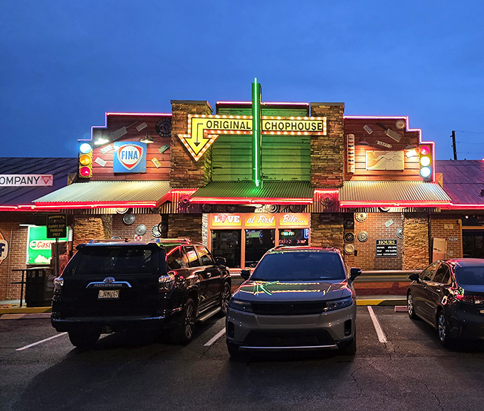Neon lights glow against rustic stone and old-school signs, giving this roadhouse a vintage highway vibe that hints at hearty meals and classic comfort inside.