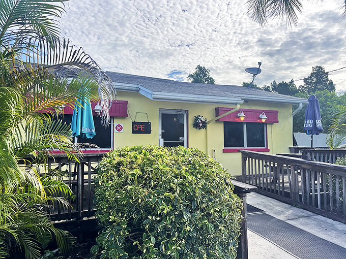 The little yellow house that could! Leo's French Toast House in Alva stands like a beacon of breakfast hope amid Florida's palm trees.