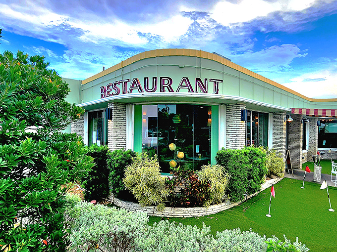 Mid-century modern meets Florida sunshine at Howley's, where the mint-green exterior promises a time-traveling culinary adventure that delivers on every level.