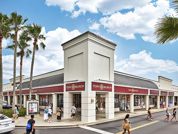 Palm trees frame the elegant Tory Burch storefront, where Florida sunshine meets designer discounts in a marriage made in shopping heaven.