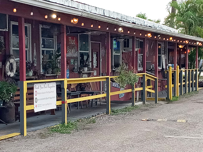 This charming red building with yellow railings proves the best food often hides behind the most unassuming facades.