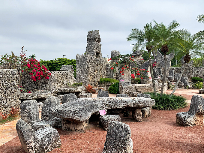 Stone pathways wind through this otherworldly garden where coral formations stand like ancient sentinels guarding secrets of impossible engineering.