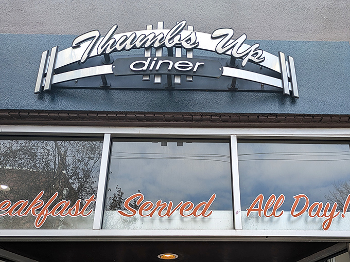The iconic Thumbs Up Diner sign promises "Breakfast Served All Day!" – a beacon of hope for late risers and breakfast enthusiasts everywhere.