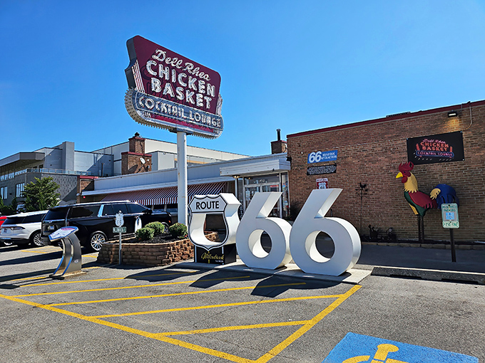 The iconic neon sign beckons hungry travelers like a lighthouse for fried chicken pilgrims. Route 66 nostalgia never tasted so good.