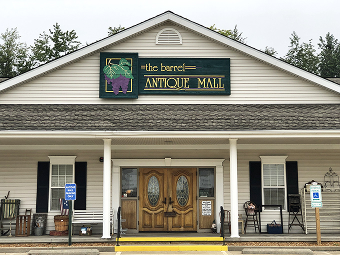 The welcoming facade of The Barrel Antique Mall beckons with its charming wooden doors and country-style porch. Time travel begins here!