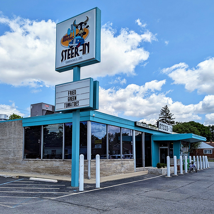 The turquoise time machine beckons! Steer-In's distinctive mid-century exterior stands proudly against the Indiana sky, promising comfort food and nostalgia in equal measure.