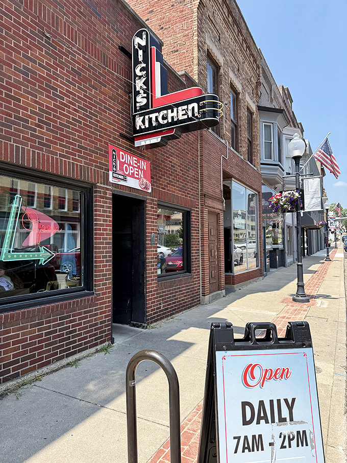 The iconic brick exterior of Nick's Kitchen, with its vintage neon sign promising culinary treasures within. Downtown Huntington's crown jewel beckons hungry travelers.