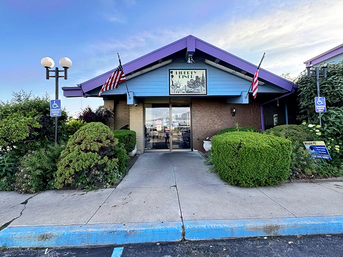 The blue-roofed sanctuary with American flags standing guard &ndash; Liberty Diner's modest exterior belies the culinary treasures waiting inside.