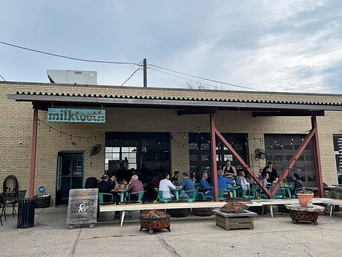 Teal chairs and wooden barrels create the perfect outdoor perch for people-watching while savoring Milktooth's inventive brunch offerings.