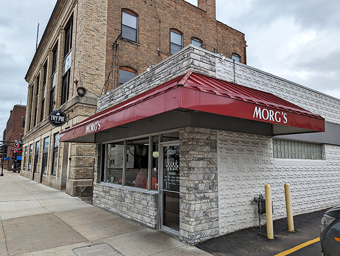 The iconic red awning of Morg's beckons hungry travelers like a breakfast lighthouse on Mulberry Street. Classic stone exterior promises timeless comfort inside.