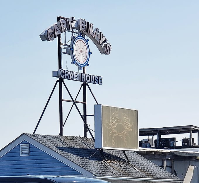 Captain Billy's iconic blue-roofed entrance beckons seafood lovers like a lighthouse for the hungry. The colorful crab mural hints at the treasures waiting inside.