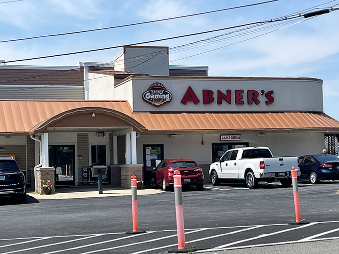 Abner's welcoming facade promises seafood treasures within. The copper-toned roof and stone accents say "Maryland crab house" before you even step inside.