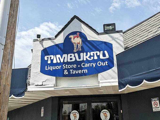 The iconic blue sign with its camel mascot promises three treasures in one stop: liquor store, carryout, and the tavern where Maryland's seafood magic happens.