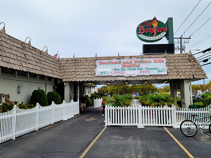 The iconic A-frame entrance to The Bonfire stands like a culinary lighthouse, beckoning hungry travelers with promises of seafood treasures within.