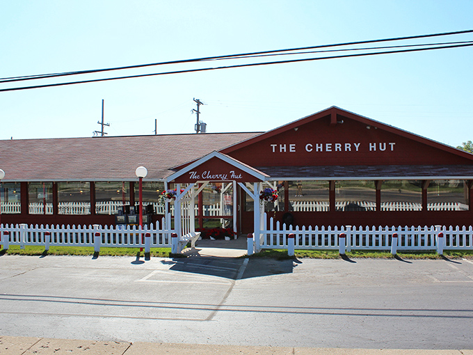 The Cherry Hut's bright red exterior and white picket fence aren't just charming&mdash;they're practically sending smoke signals to your sweet tooth from miles away.