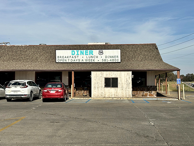 The classic roadside promise of "BREAKFAST, LUNCH, DINNER" never looked so inviting. Diner 54's vintage sign beckons hungry travelers like a lighthouse for the famished.