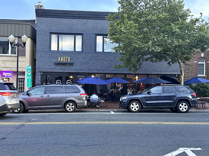 The sleek blue-gray exterior of Aarzu stands proudly on Freehold's Main Street, with outdoor seating that beckons passersby like a culinary siren song.