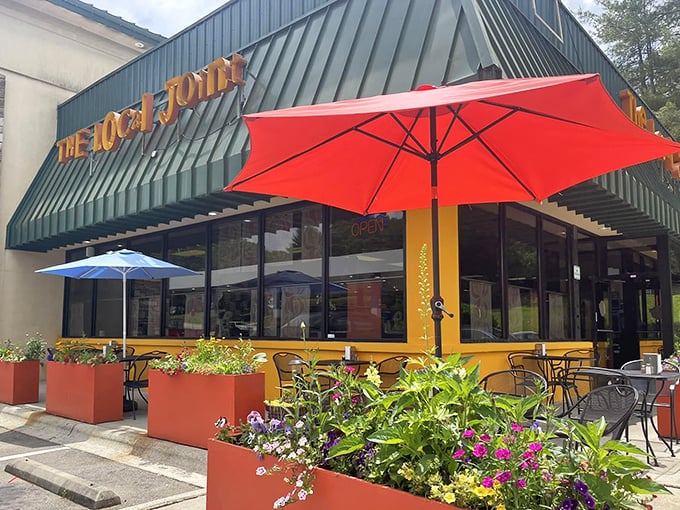 The Local Joint's vibrant exterior welcomes hungry travelers with colorful planters and cheerful umbrellas &ndash; breakfast paradise found!