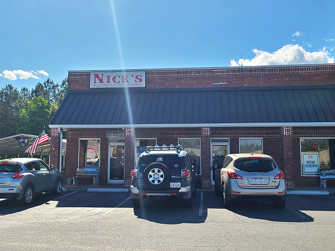 The brick fortress of flavor that is Nick's stands proudly under Carolina blue skies, promising old-fashioned burgers that time forgot but taste buds remember.