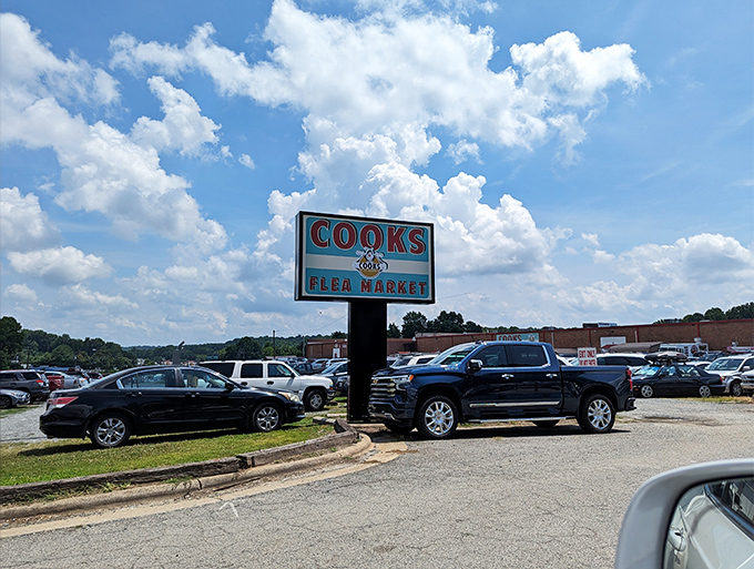 The iconic Cooks Flea Market sign stands tall against Carolina blue skies, beckoning treasure hunters from miles around.
