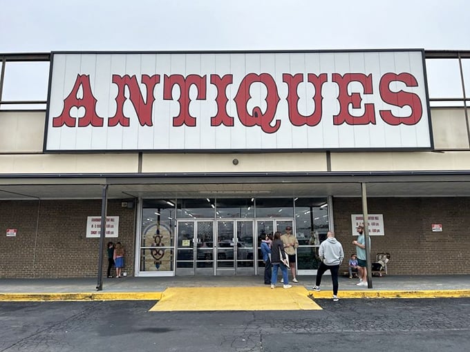 That bold red "ANTIQUES" sign beckons treasure hunters like a lighthouse guides ships to shore.