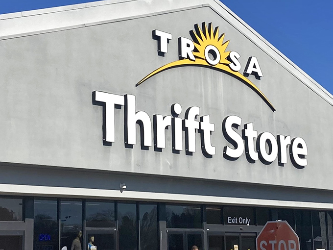 The iconic TROSA Thrift Store sign welcomes bargain hunters with its cheerful sunrise logo &ndash; a beacon of hope and hidden treasures in Durham.