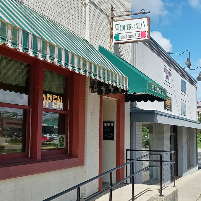 The iconic green and white striped awning of The Mediterranean is like a beacon for hungry travelers on Wilmington's Main Street, promising authentic flavors behind its modest fa&ccedil;ade.