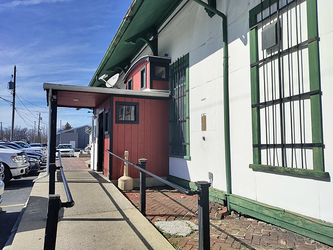 The unassuming red exterior of Depot Pizza tells you everything you need to know—this place cares more about what's inside than fancy curb appeal.