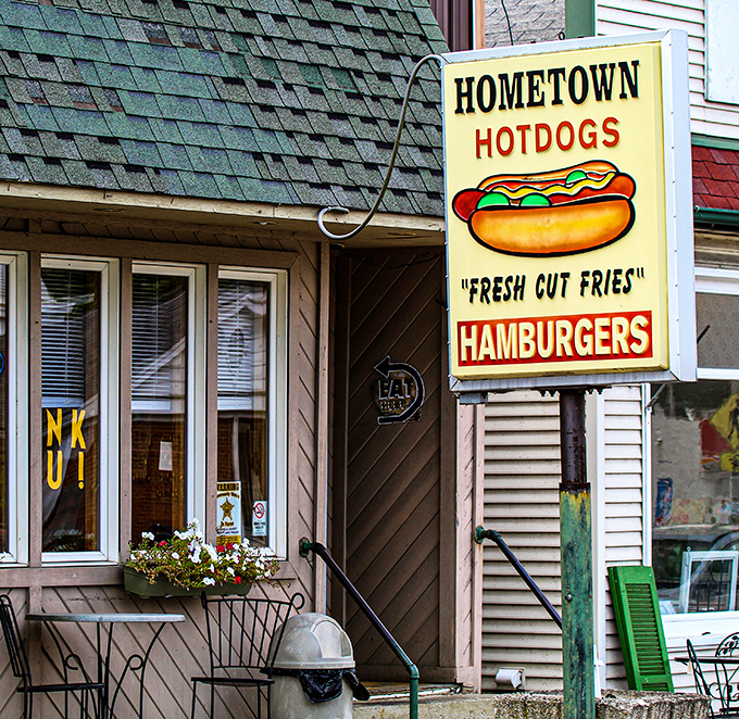 That iconic yellow sign says everything you need to know: hot dogs, fresh-cut fries, and hamburgers await. No fancy marketing needed when the food speaks for itself.