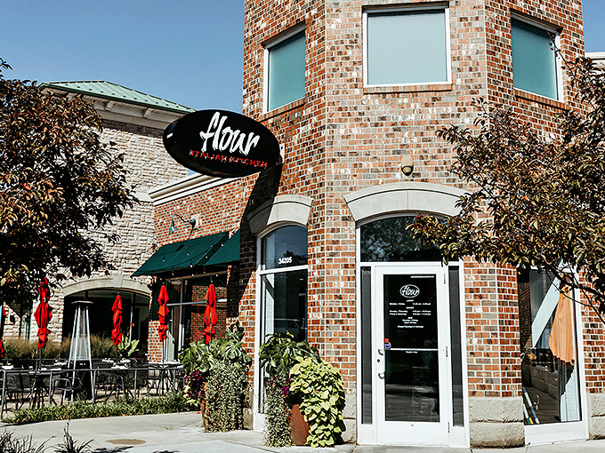 Flour's distinctive brick exterior with its elegant oval sign promises Italian delights within. Those red umbrellas aren't just for show&mdash;they're inviting you to linger over aperitivos on warm Ohio evenings.