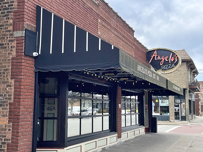 The brick facade of Angelo's Pizza in Lakewood beckons like an old friend. That neon sign promises comfort and satisfaction just steps away.