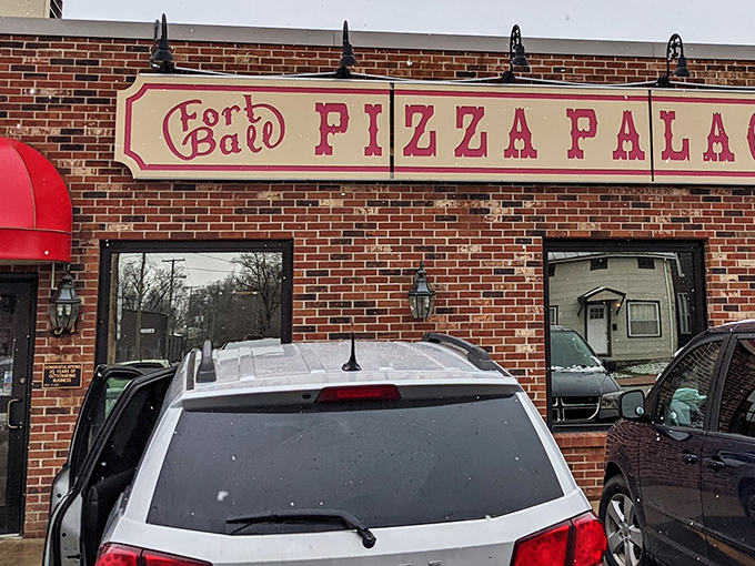 The brick facade of Fort Ball Pizza Palace stands as a testament to Tiffin's enduring love affair with no-nonsense, delicious pizza.
