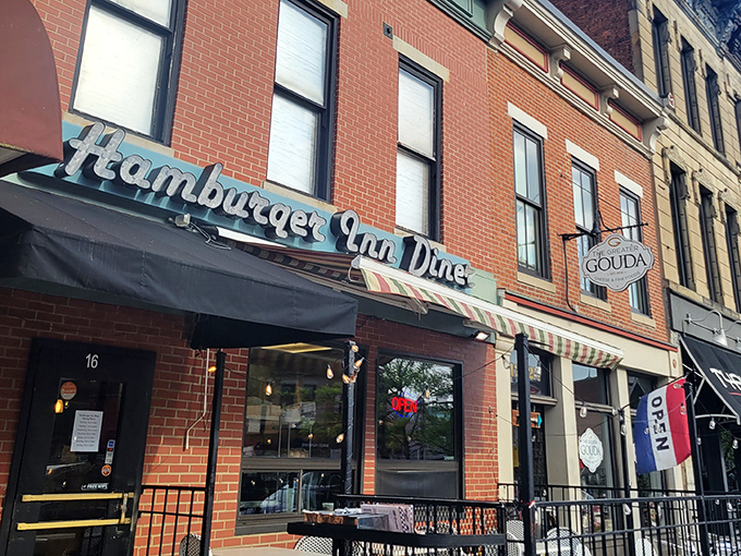 The classic neon sign of Hamburger Inn Diner beckons from its brick facade like a time machine to when conversation mattered more than Wi-Fi passwords.