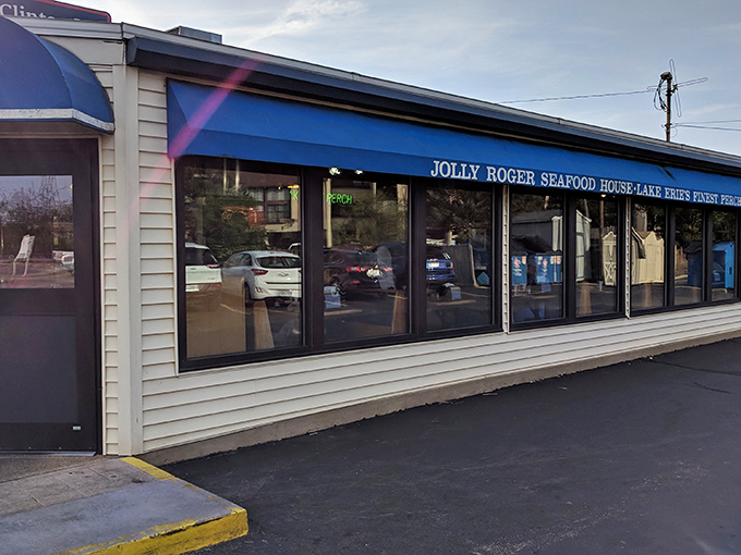 The unassuming blue awning of Jolly Roger Seafood House beckons like a lighthouse for hungry travelers. Lake Erie's seafood sanctuary hides in plain sight.