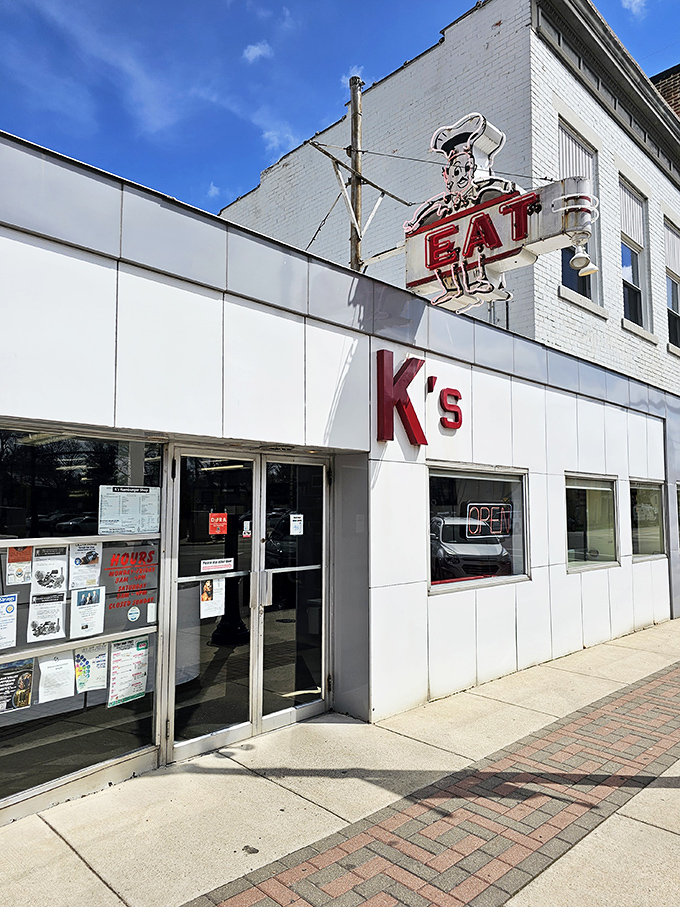 The iconic chef sign beckons hungry travelers like a culinary lighthouse. This white-fronted time capsule on Troy's Main Street promises simple perfection inside.