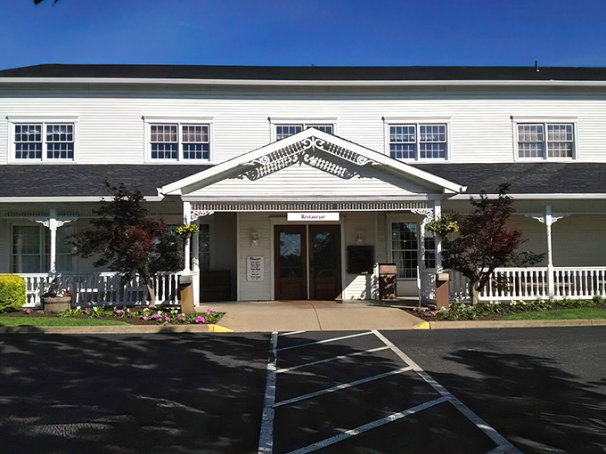 The Amish Door's stately white exterior welcomes visitors like an old friend, complete with autumn trees that seem to have dressed up specially for your arrival.