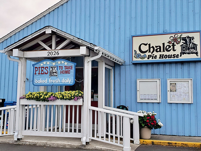 The sky-blue exterior of Chalet Pie House beckons like a siren song to pie lovers, complete with cheerful flower boxes and that magical "PIES TO TAKE HOME" promise.