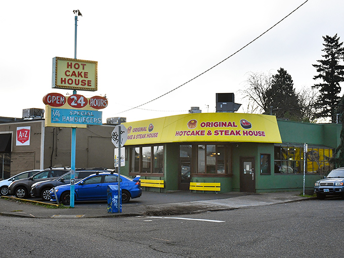 The unmistakable yellow and green exterior of Original Hotcake House stands like a breakfast beacon in Portland, promising comfort food salvation 24 hours a day.