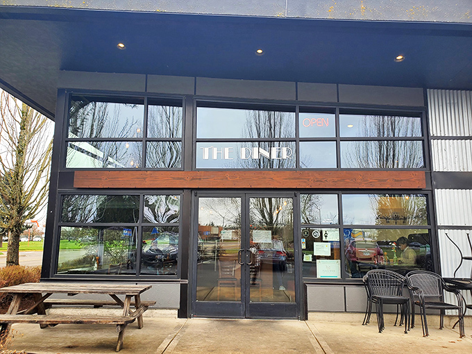 The modern exterior of The Diner defies nostalgic expectations, offering a sleek architectural welcome that says, "This isn't your grandpa's greasy spoon."